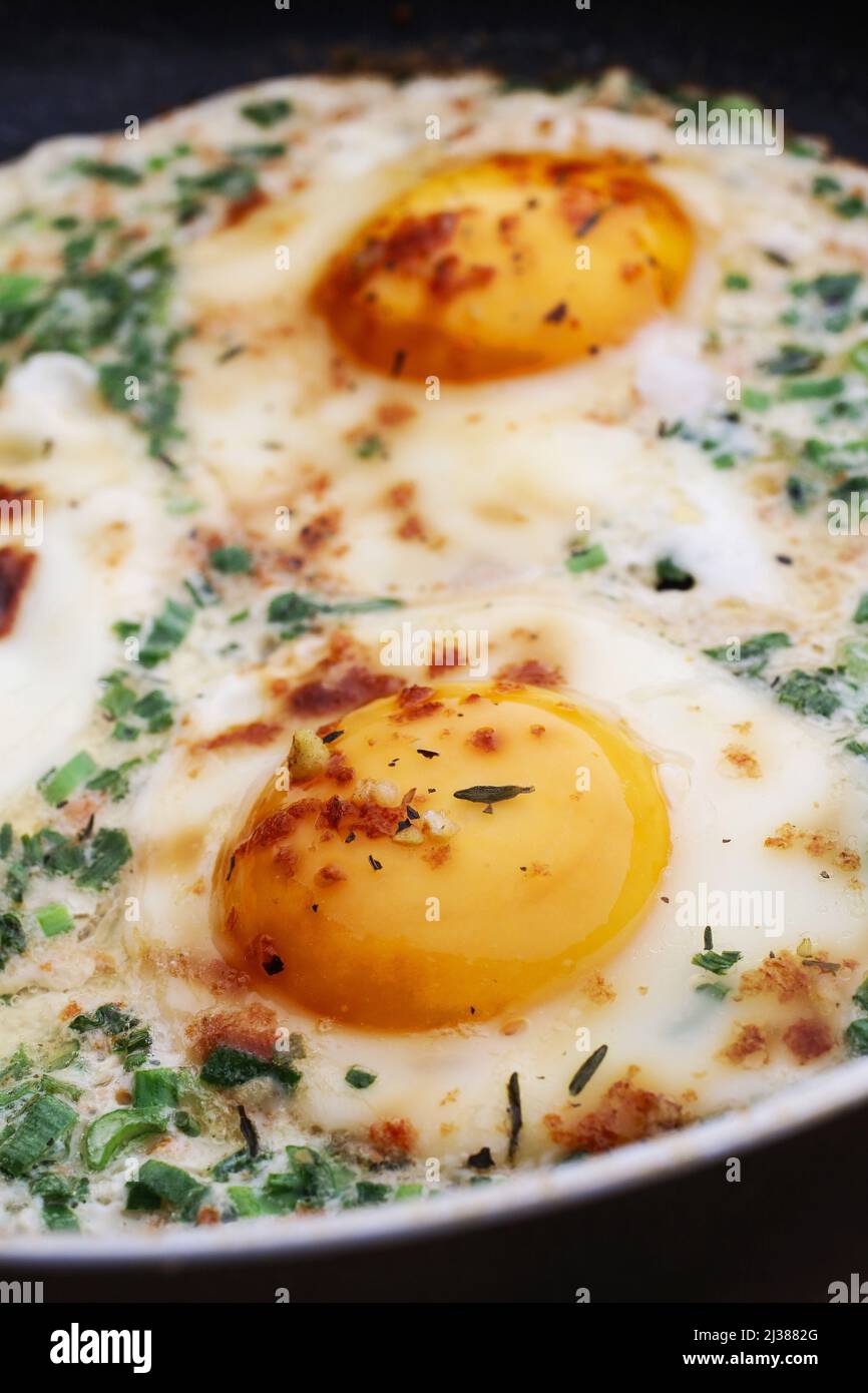 Consecutive steps of preparing fried eggs with ham and herbs. Step by ...