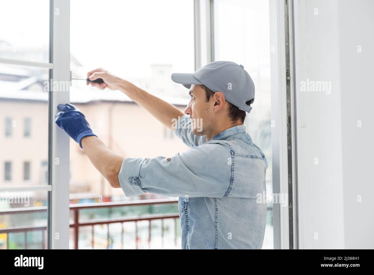 The worker installing and checking window in the house Stock Photo - Alamy