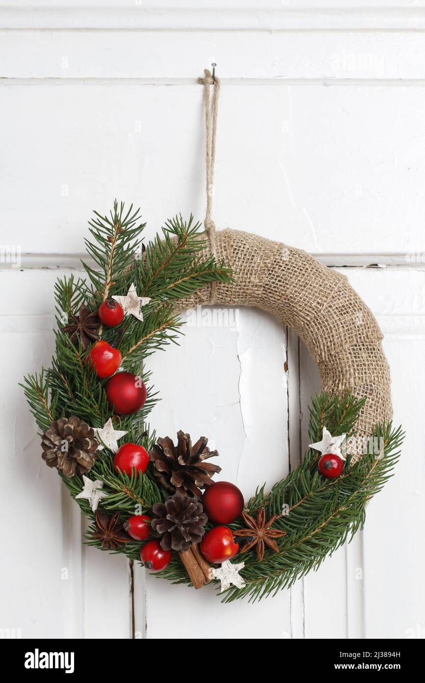 Florist at work: woman shows how to make classic Christmas door wreath ...
