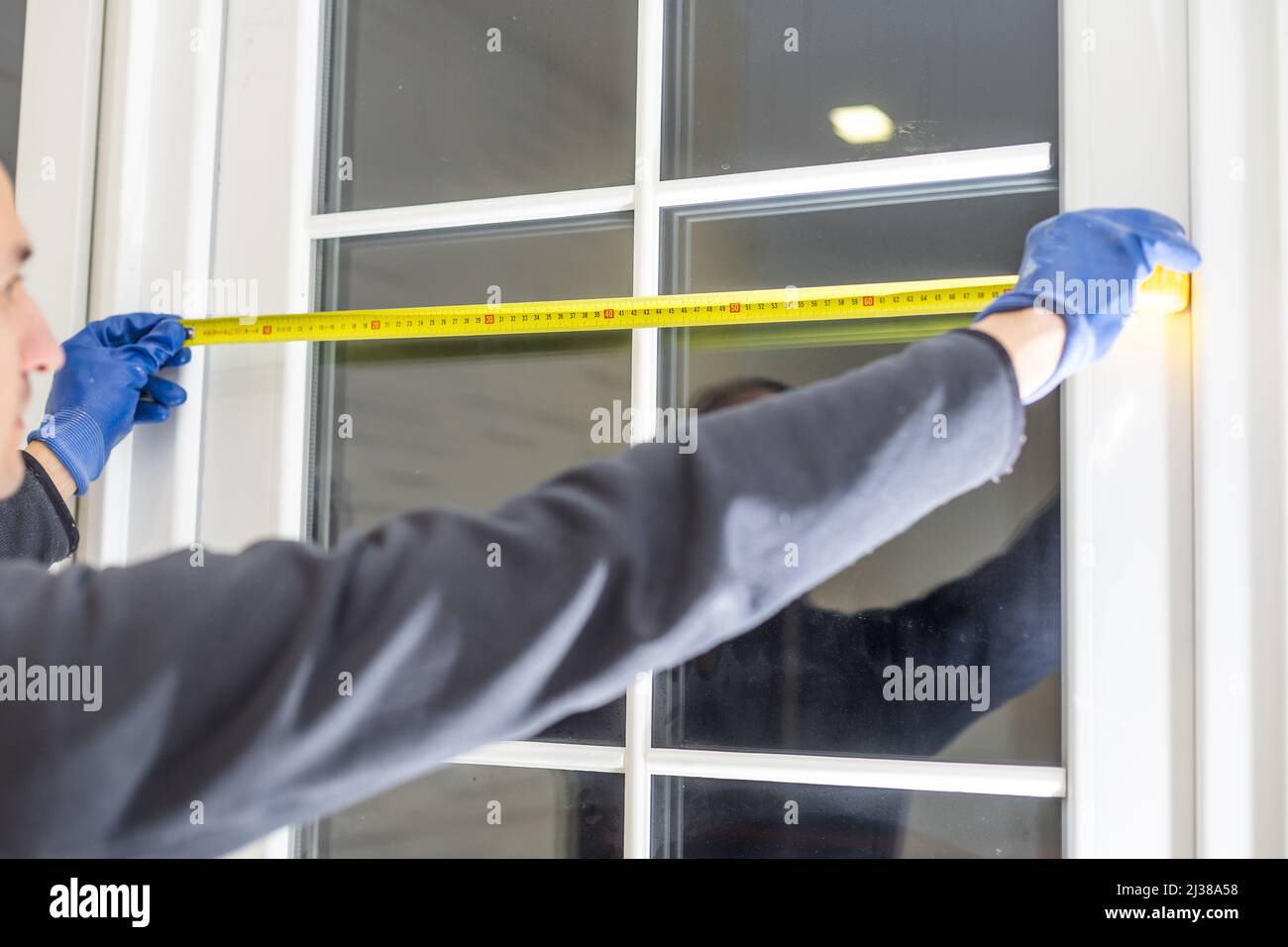 Construction worker installing window in house Stock Photo - Alamy