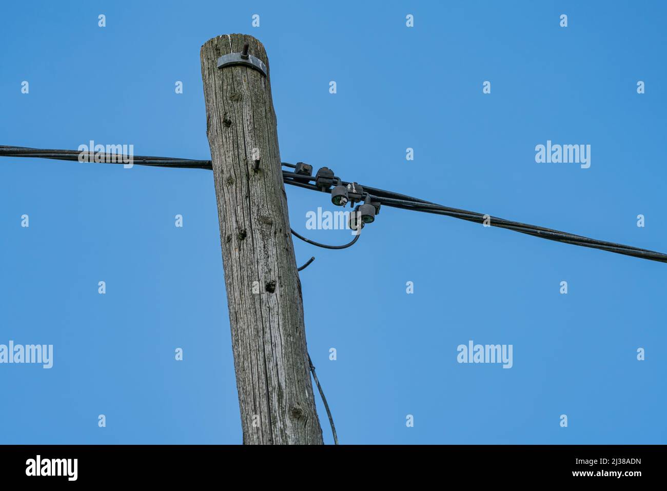 Connections on an old, wooden electricity pole against the sky Stock ...