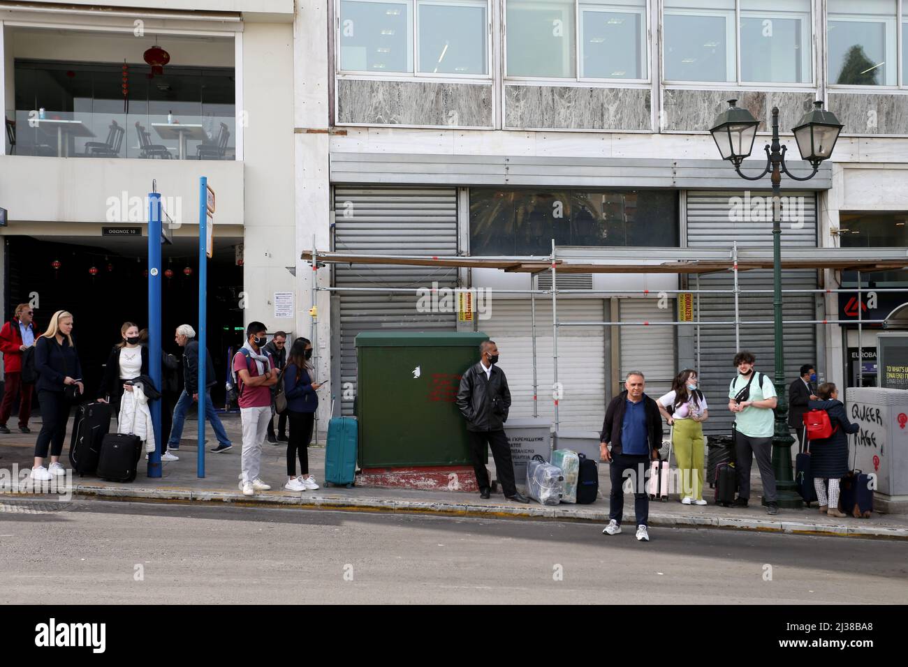 People waiting for bus at a bus stop in Athens Greece Stock Photo - Alamy