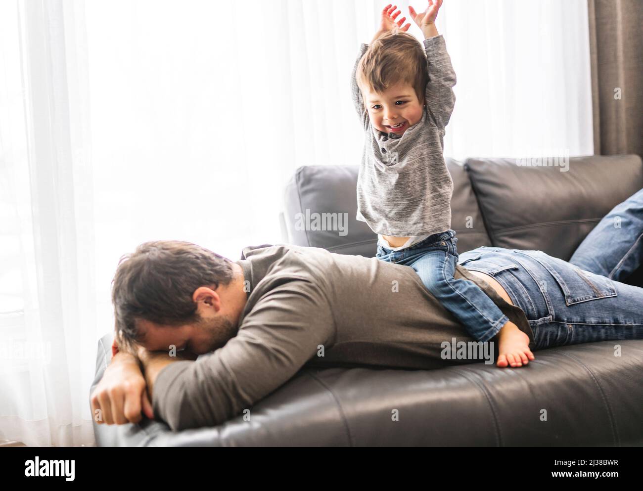 Tired young father with boy on back a concept of hyperactive children ...