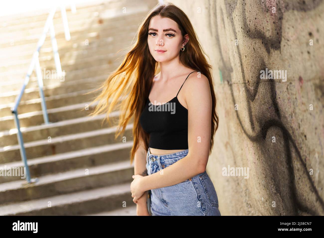 Nice and cool teen girl standing portrait on concreate place Stock ...