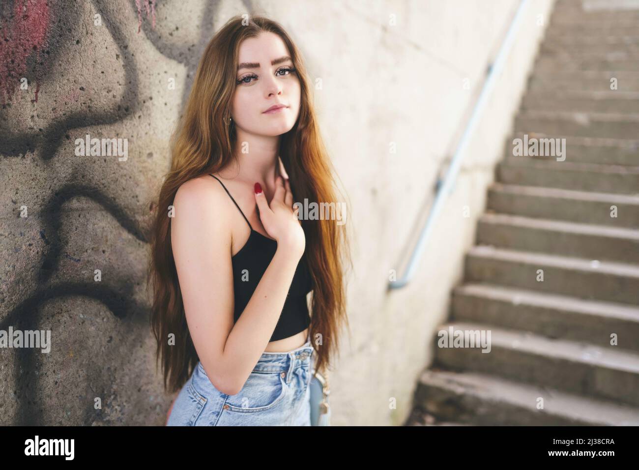 Nice and cool teen girl standing portrait on concreate place Stock ...