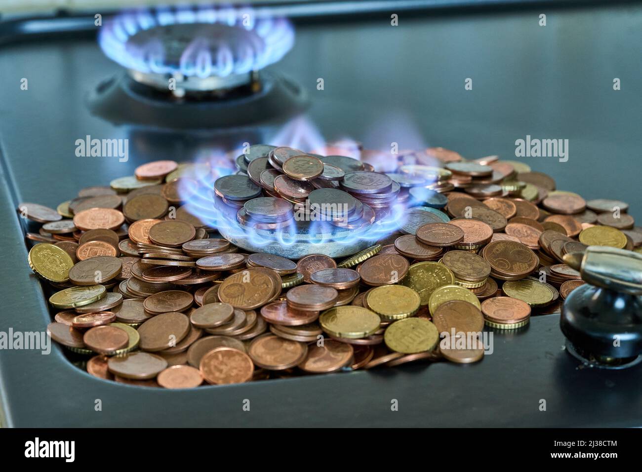 Euro metal coins burning in the gas stove Stock Photo - Alamy