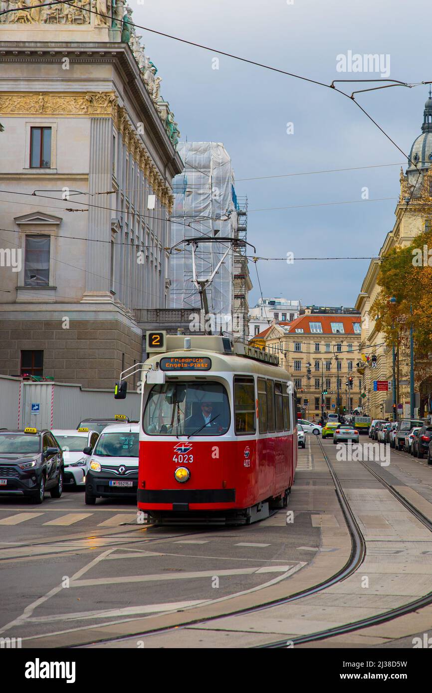 Man driving a red electric tram during the day in Vienna, Austria. Tram ...