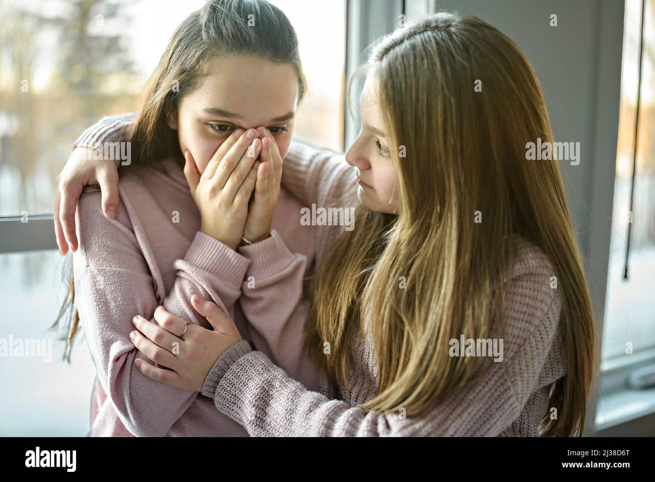 Teenage girl consoling her sad friend on her bedroom Stock Photo - Alamy