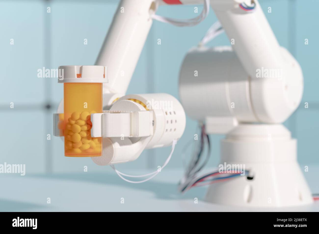 Robot arm with a pills in bottle in the laboratory. The concept of ...