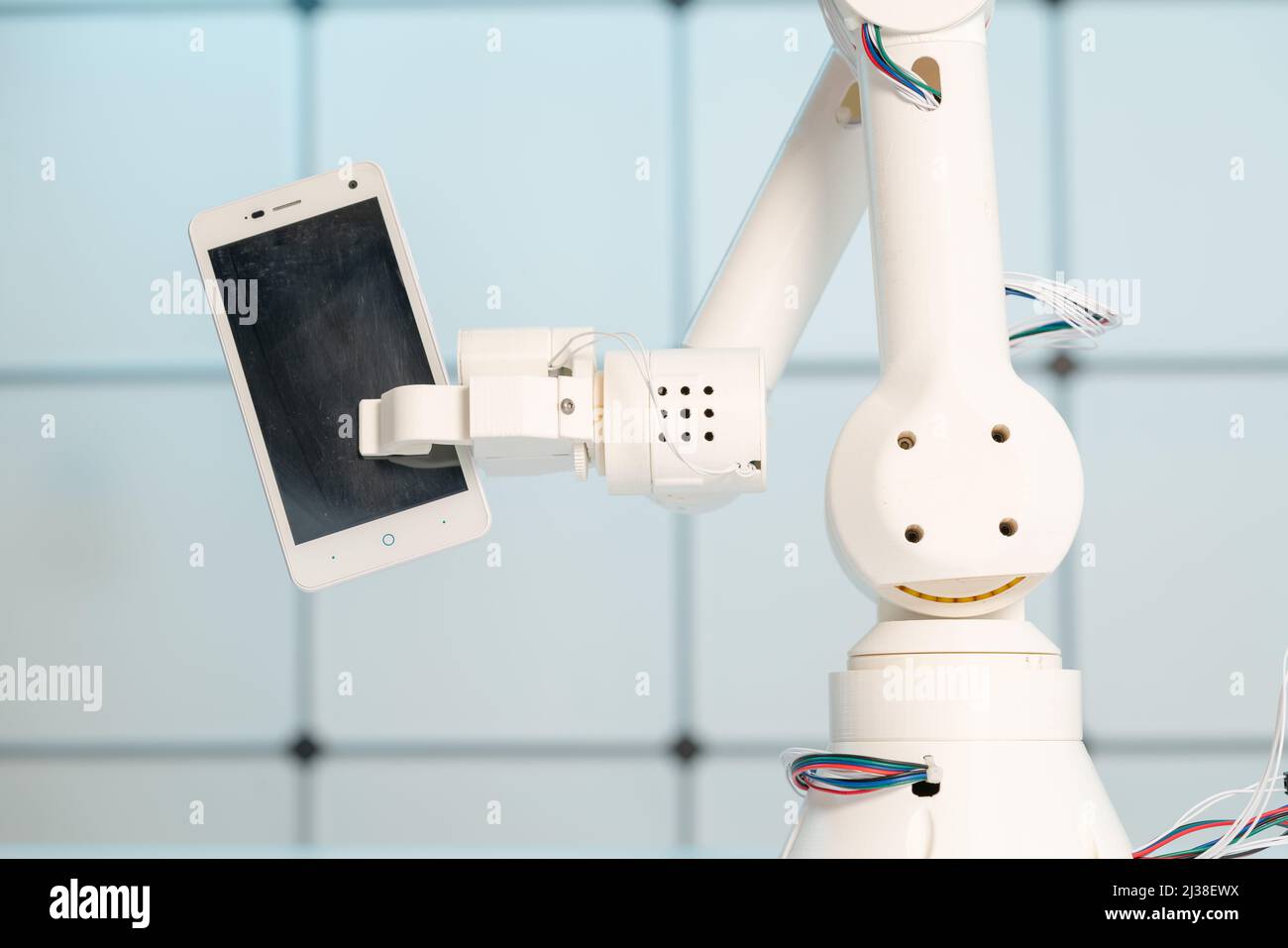 Phone in robot arm, bot concept on customer support hotline. Using ...