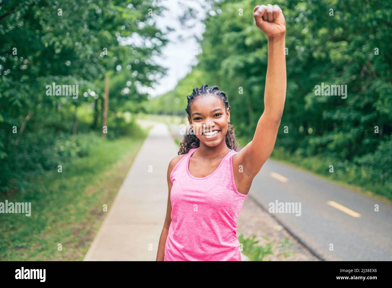 Woman runner in action outside in tree background Stock Photo - Alamy