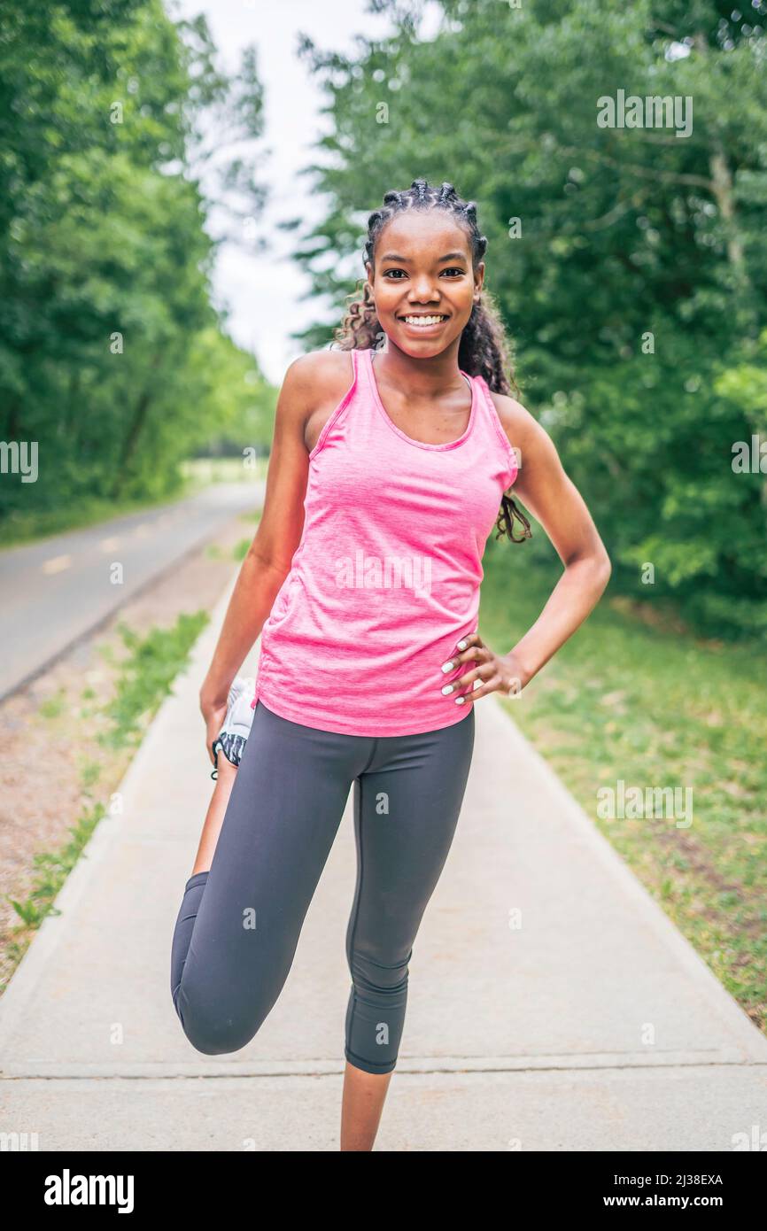 Woman runner in action outside in tree background Stock Photo - Alamy