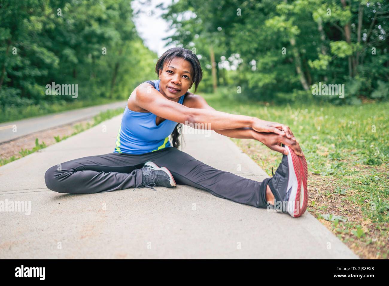 Woman runner in action outside in tree background Stock Photo - Alamy