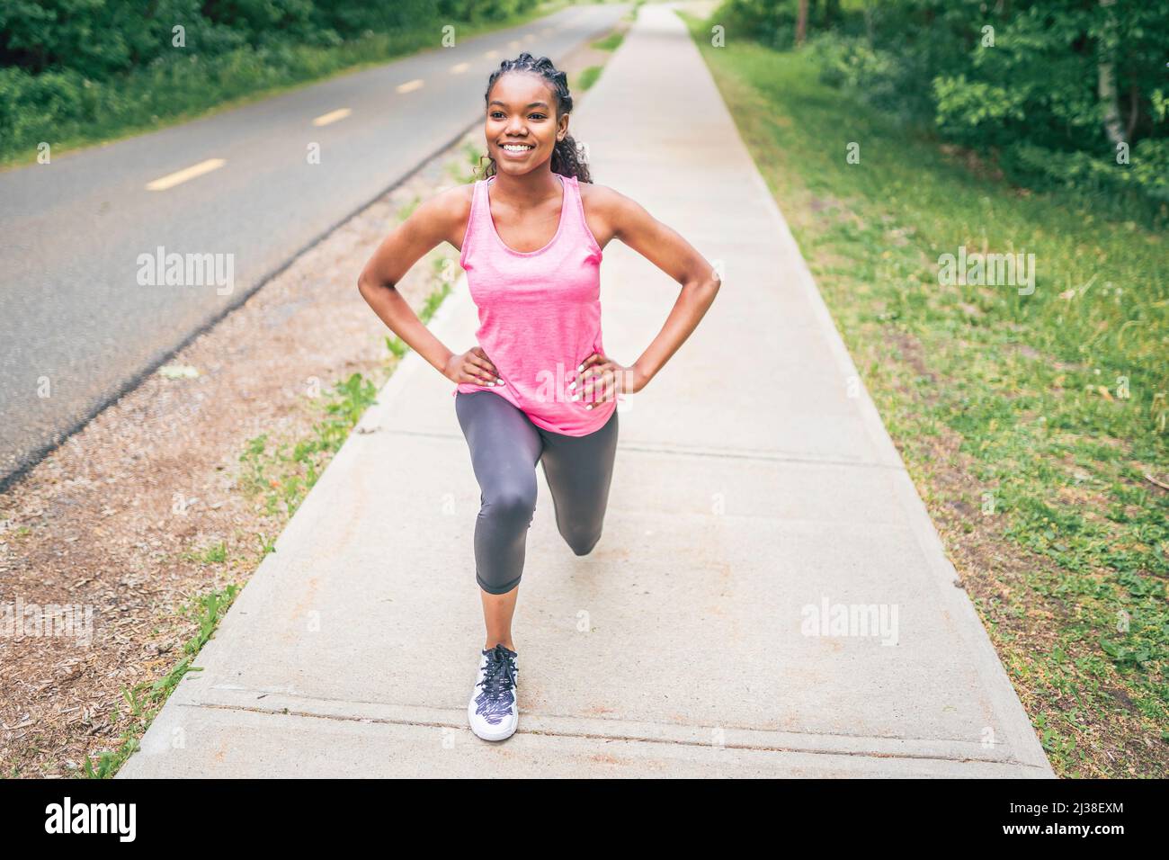 Woman runner in action outside in tree background Stock Photo - Alamy