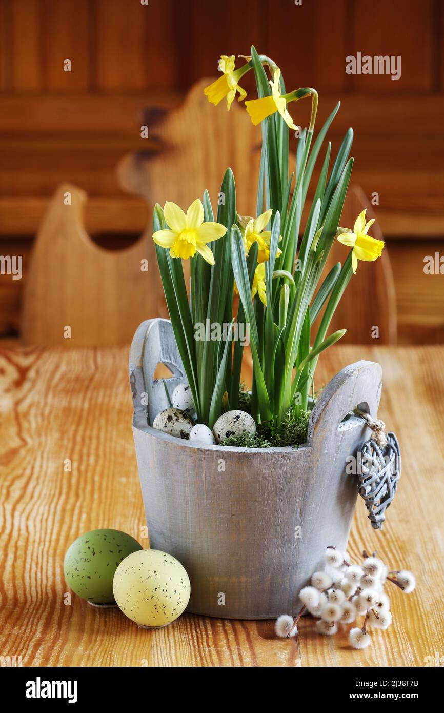 Beautiful spring flowers on wooden table. Traditional Easter decoration ...
