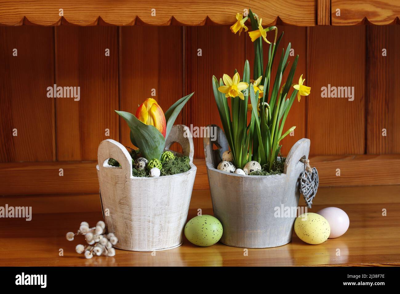 Beautiful spring flowers on wooden table. Traditional Easter decoration ...
