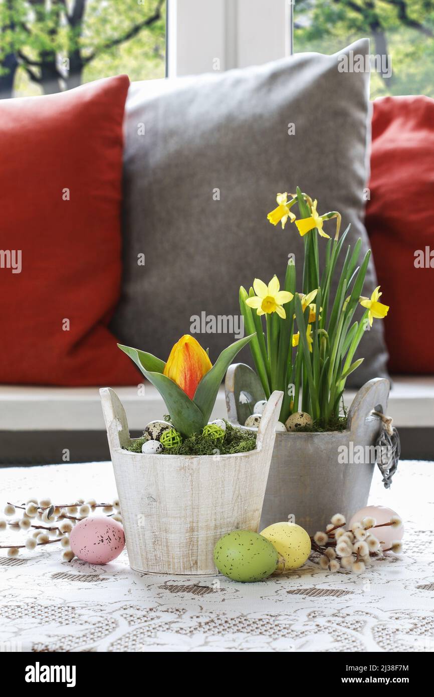 Beautiful spring flowers on wooden table. Traditional Easter decoration ...