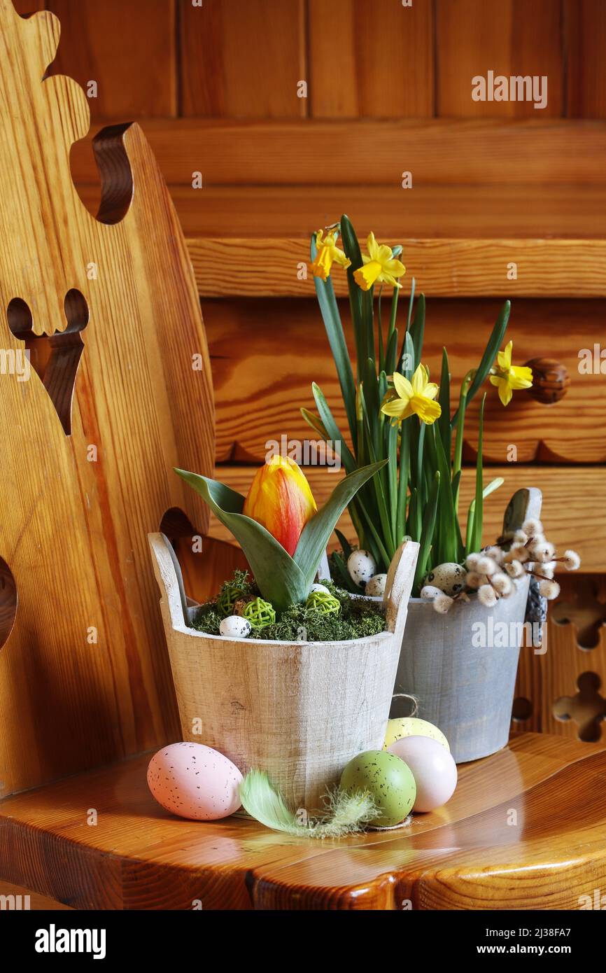 Beautiful spring flowers on wooden table. Traditional Easter decoration ...