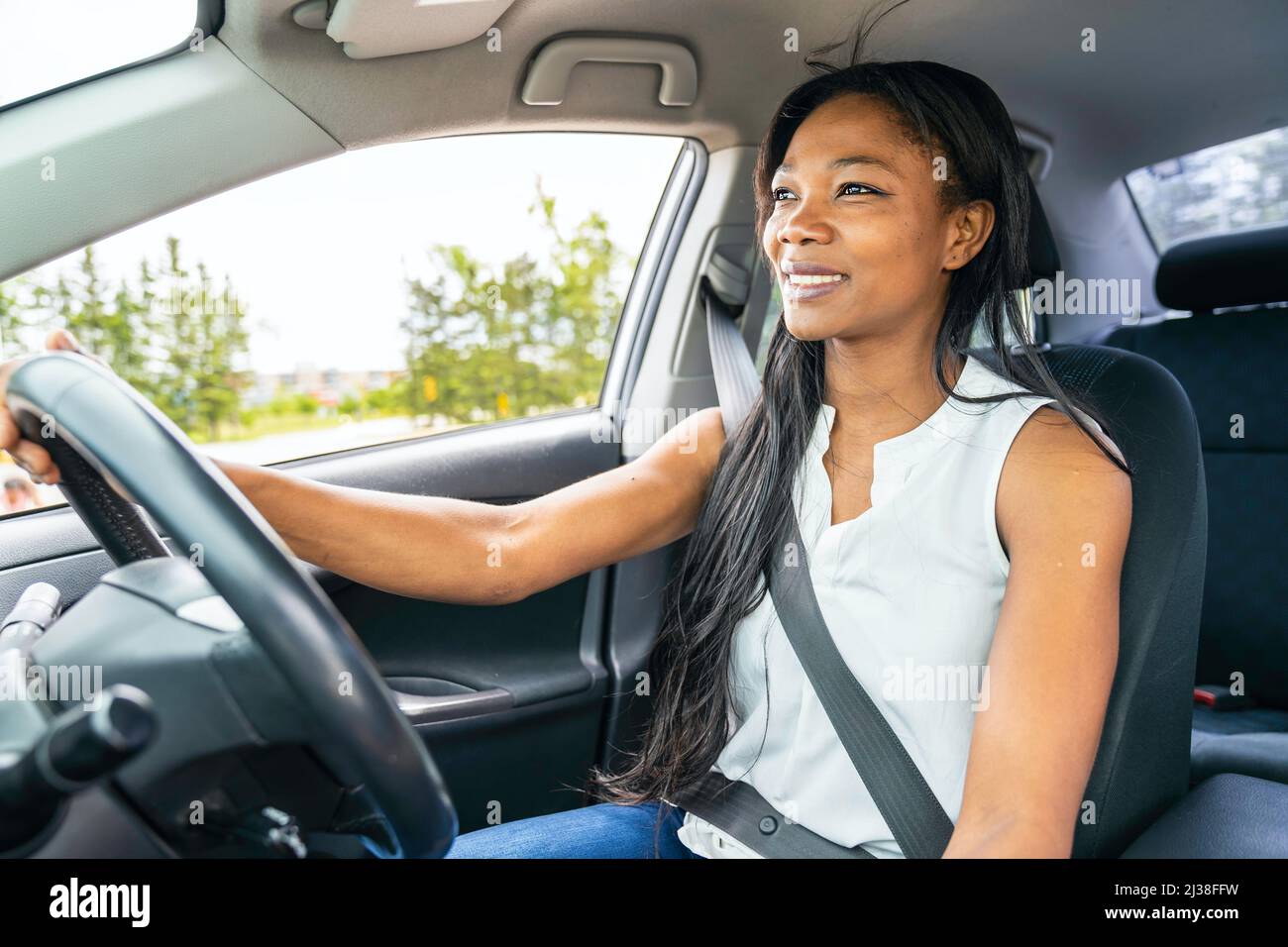 black woman driver seated in her new car Stock Photo - Alamy