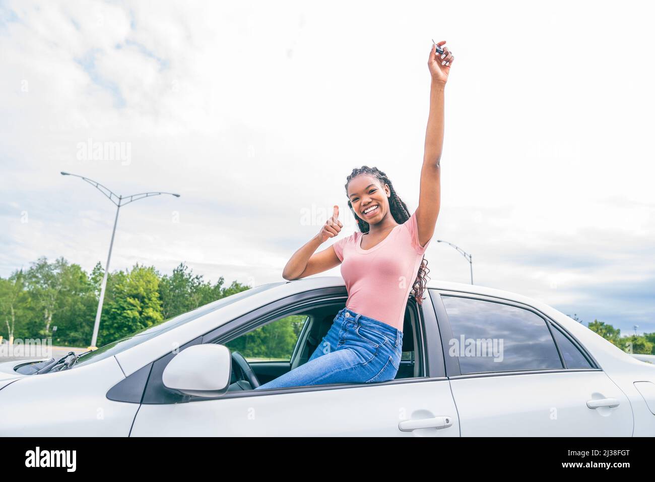 Young black teenage driver seated in her new car Stock Photo - Alamy