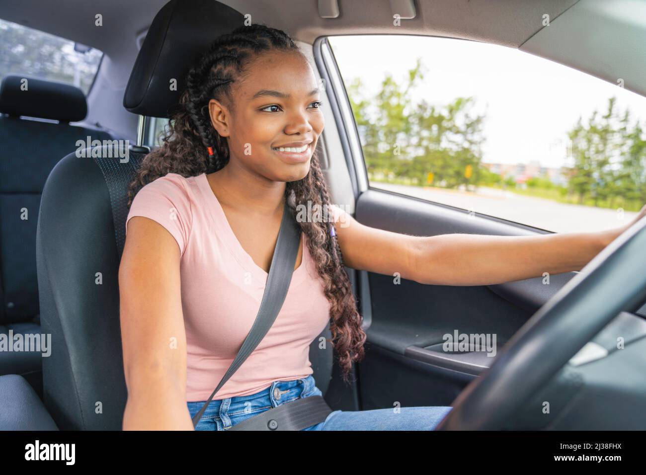 Young black teenage driver seated in her new car Stock Photo - Alamy