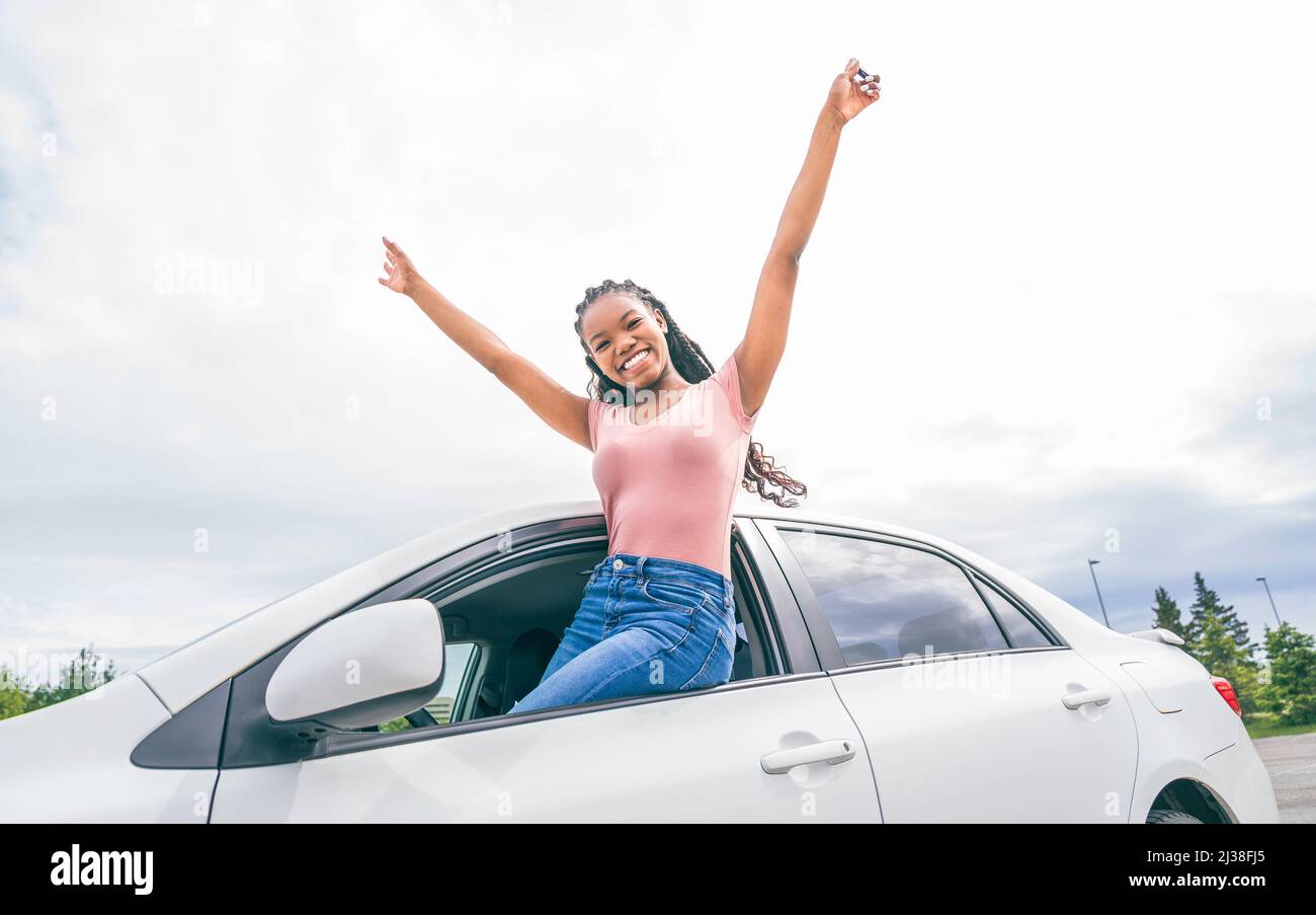 Young black teenage driver seated in her new car Stock Photo - Alamy