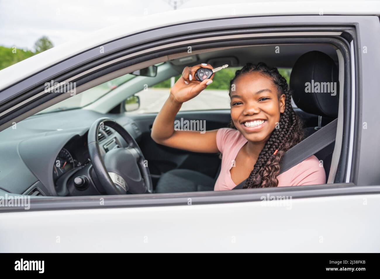 Young black teenage driver seated in her new car Stock Photo - Alamy