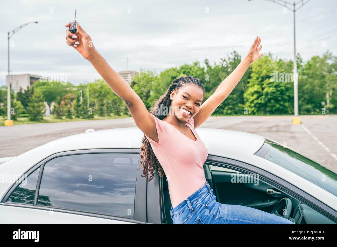 Young black teenage driver seated in her new car Stock Photo - Alamy