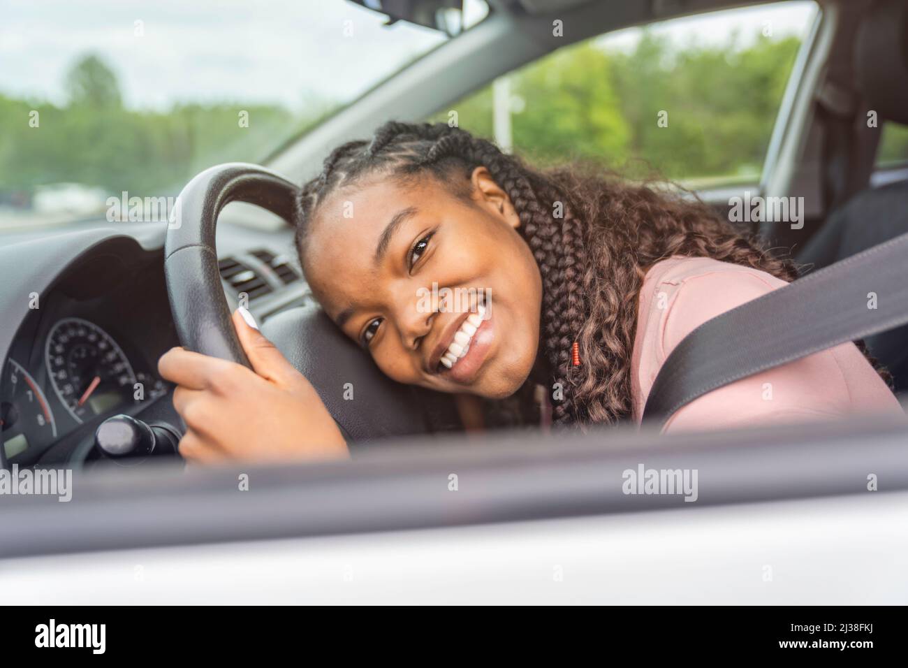 Young black teenage driver seated in her new car Stock Photo - Alamy