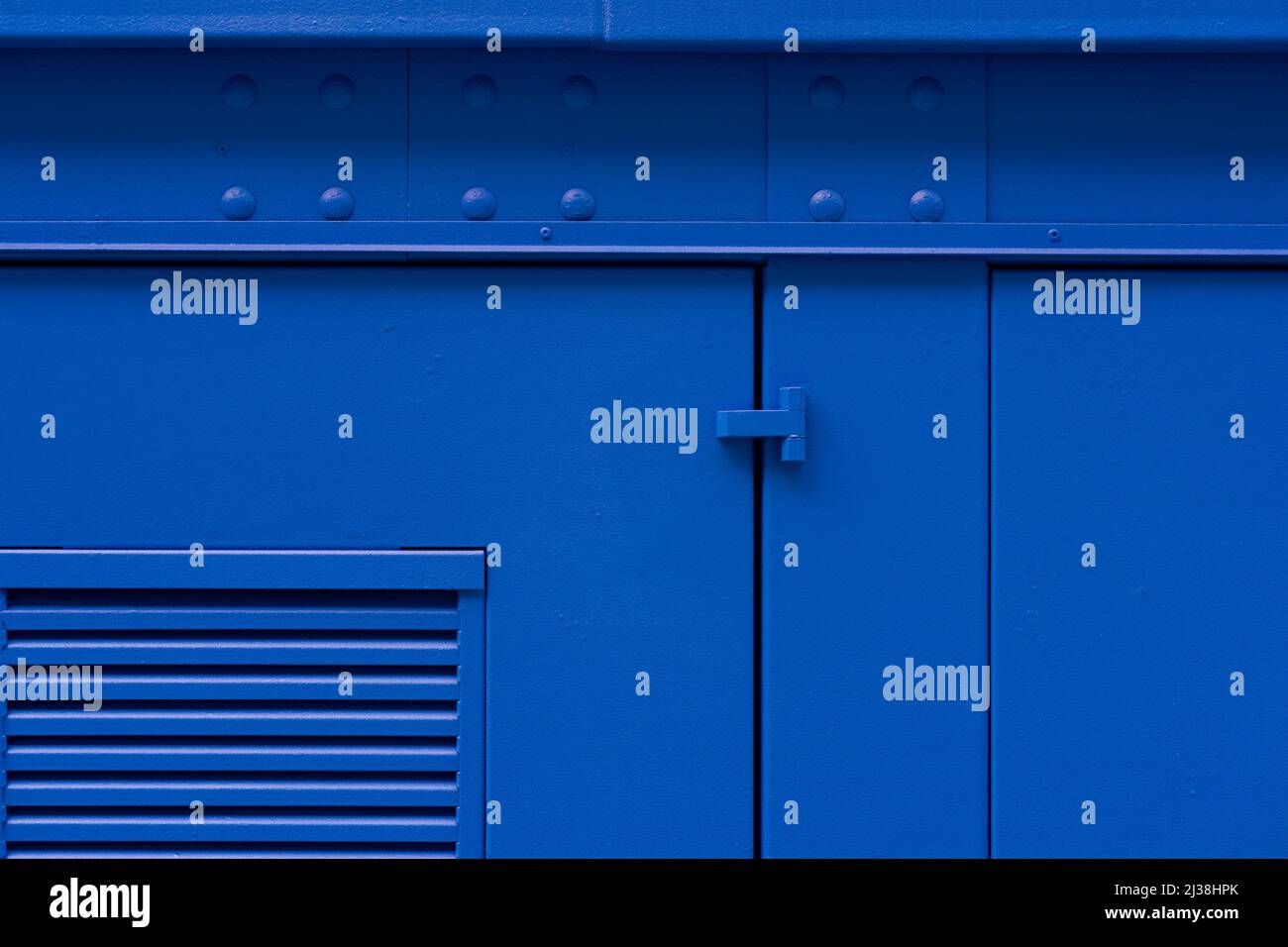 Blue painted iron wall with door Stock Photo - Alamy