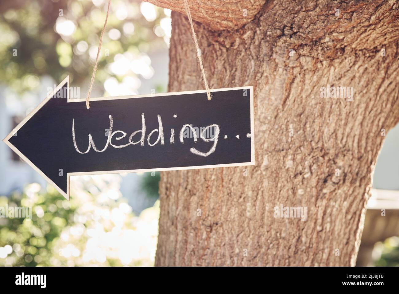 Follow the arrow to our wedding reception. Shot of a arrow directing ...