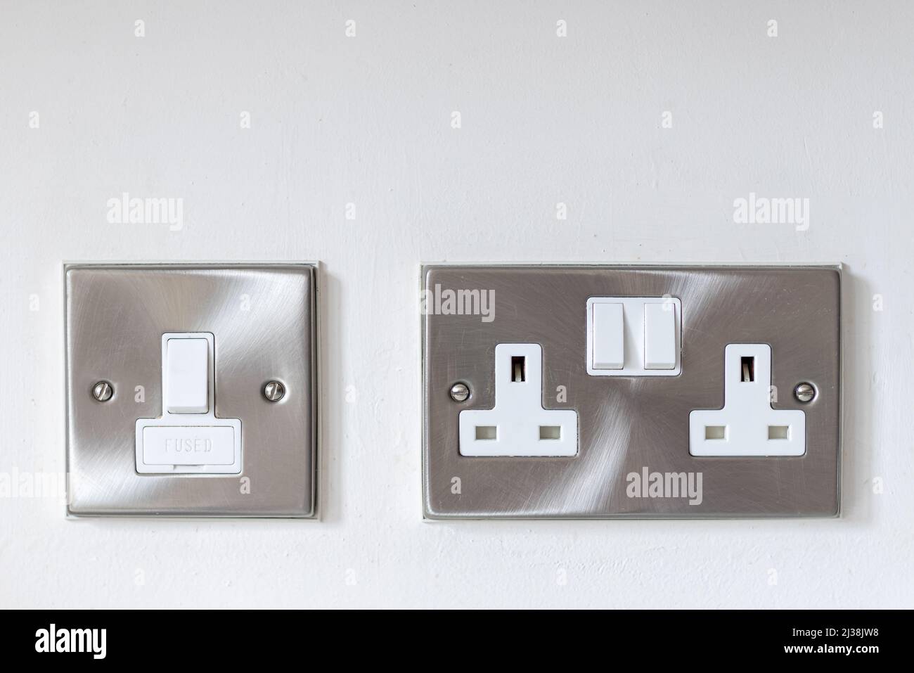 Stainless steel electric double socket and a fused switch mounted on a ...