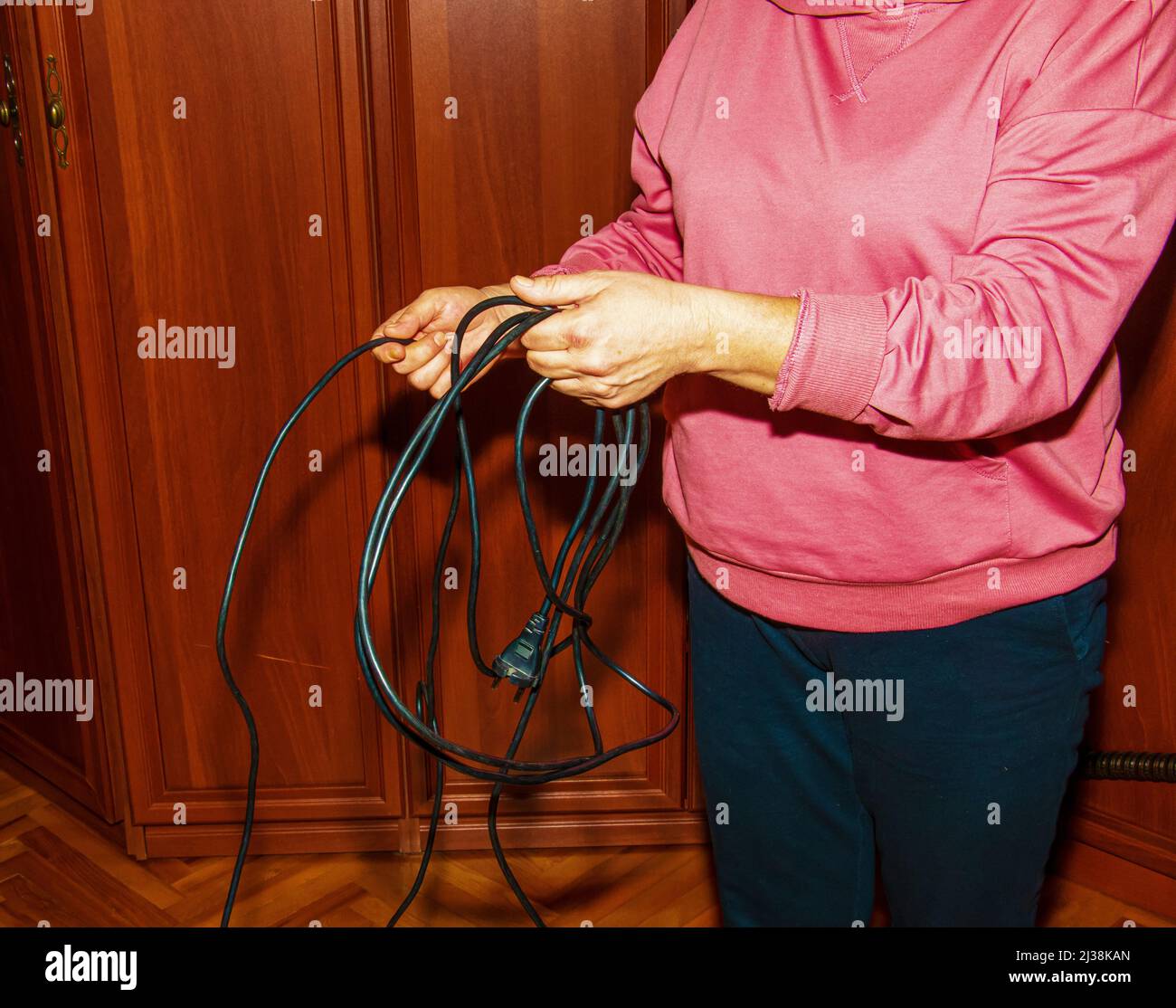 Woman's hands hold an electric cable. Black cable, electronics Stock ...
