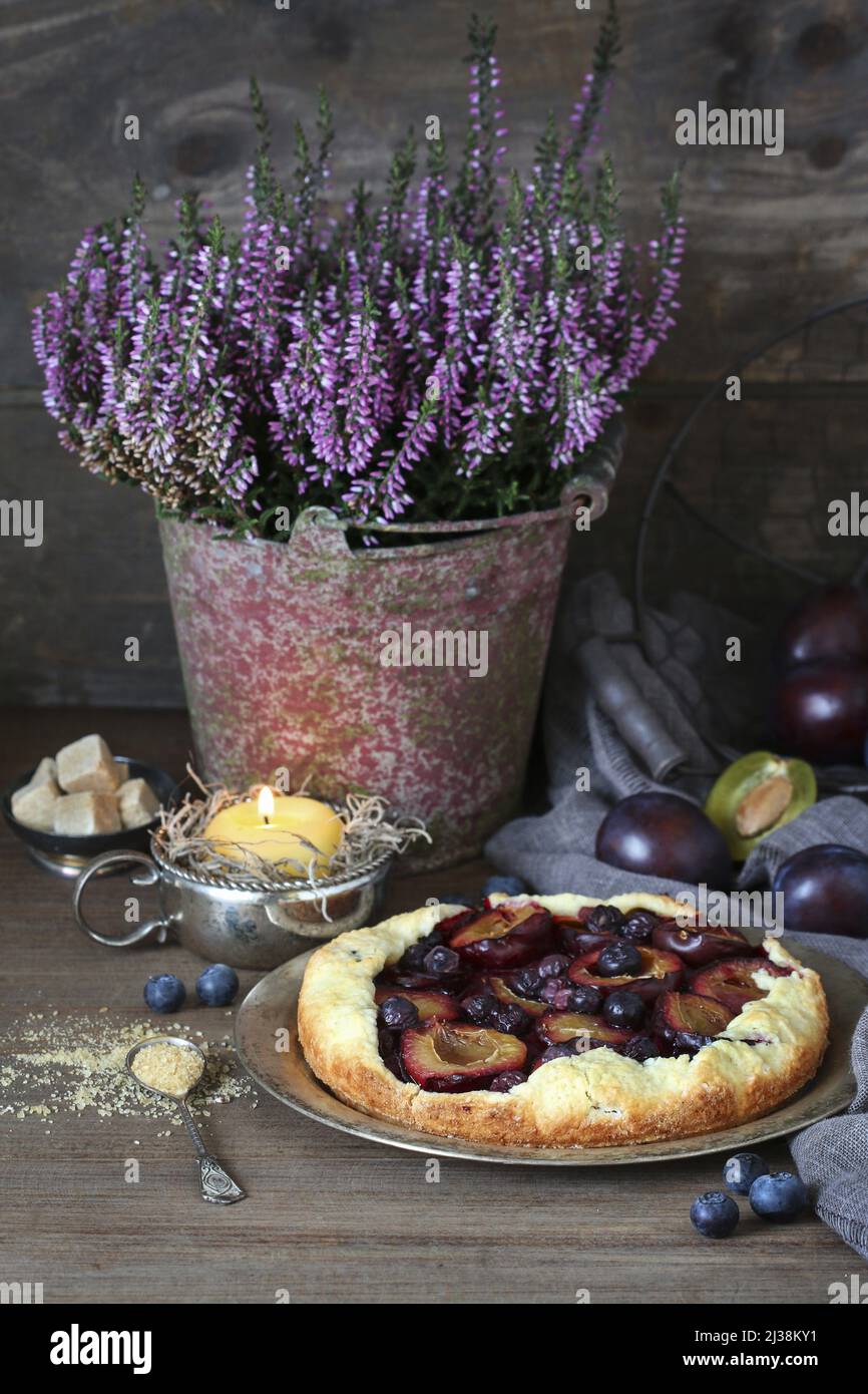 Heather (Calluna vulgaris) in vintage bucket. Autumn decor Stock Photo ...