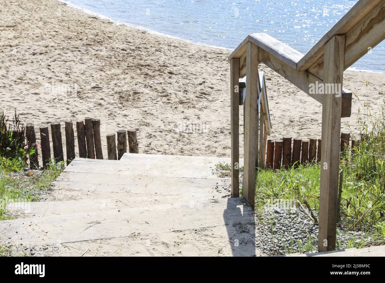 Wooden stairs leading to the seaside, sandy beach. Tourists destination ...