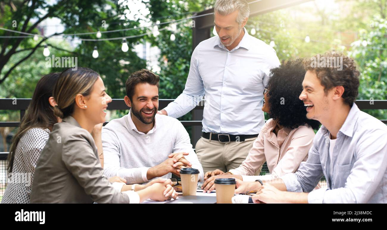 Merging their ideas around the table. Shot of a group of colleagues ...