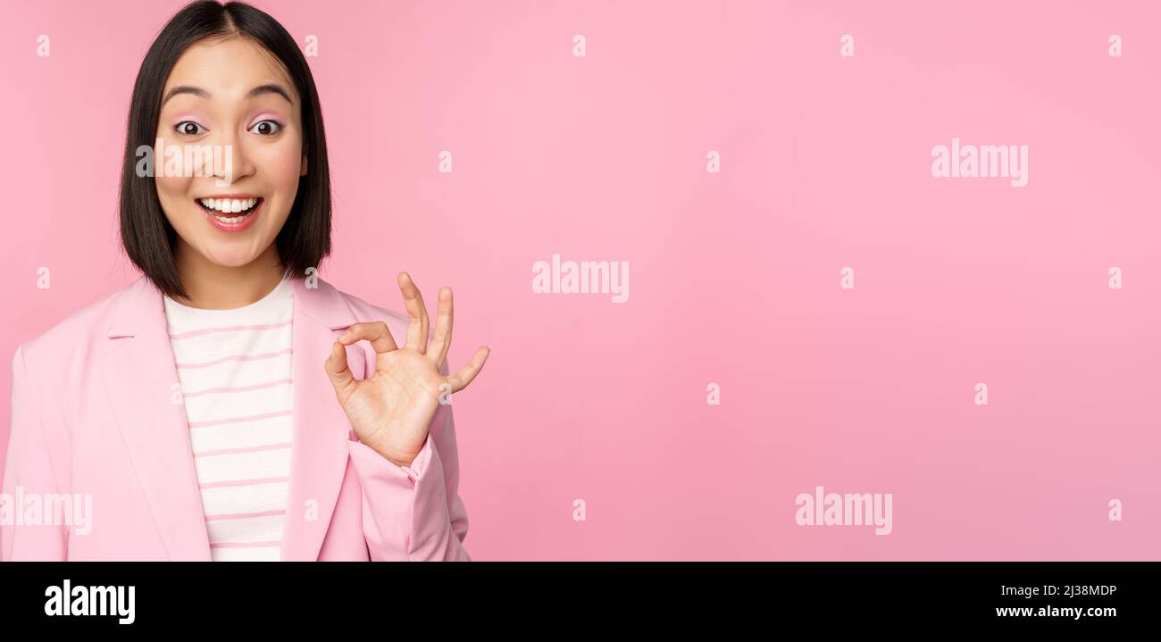 Very good. Happy korean businesswoman smiling pleased, showing okay, ok ...