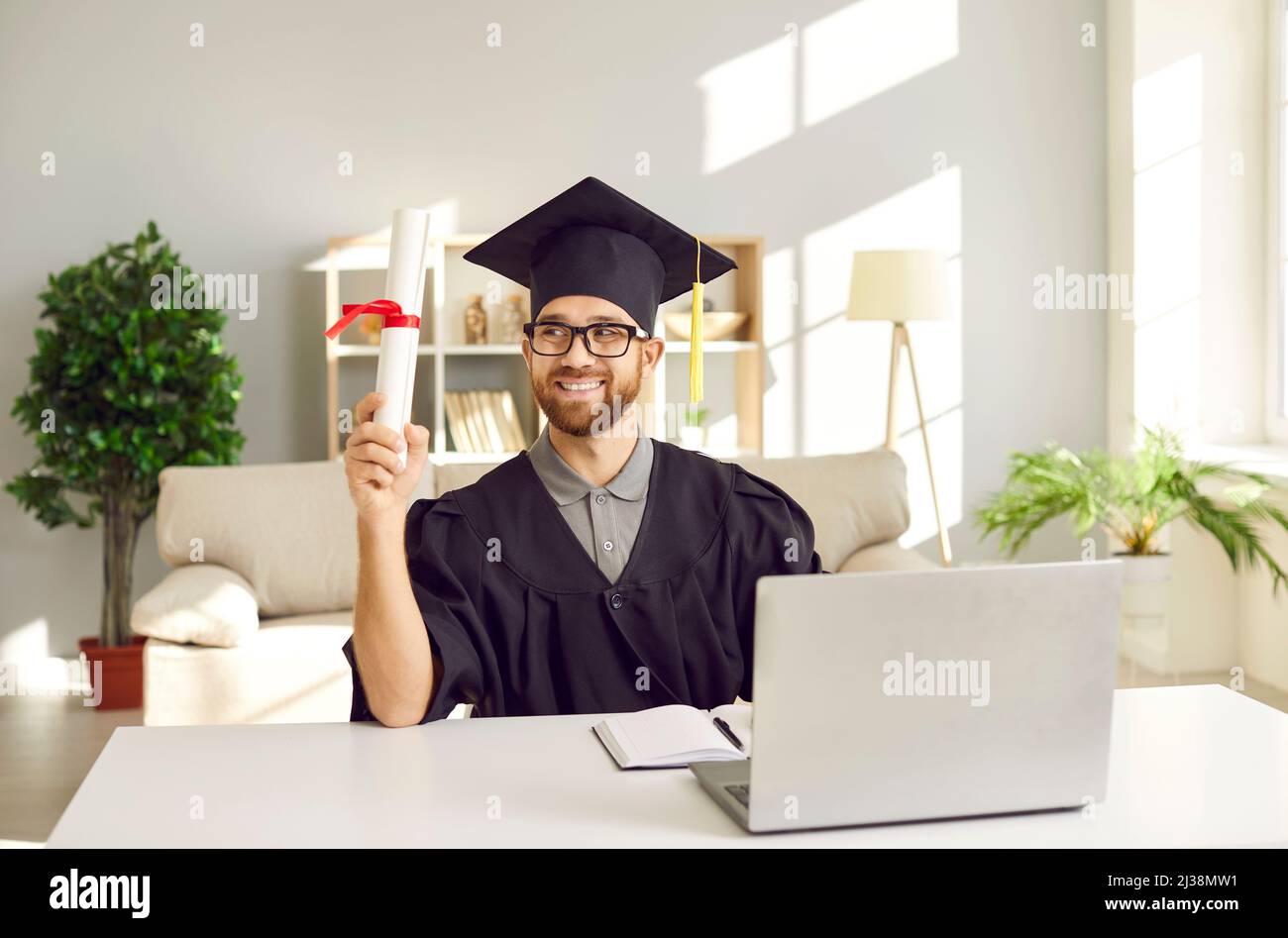 Happy student graduate from college studying online Stock Photo - Alamy