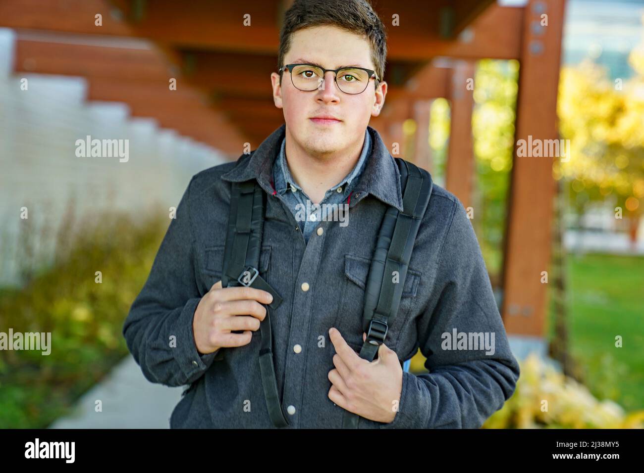 Student with backpack outside university school Stock Photo - Alamy