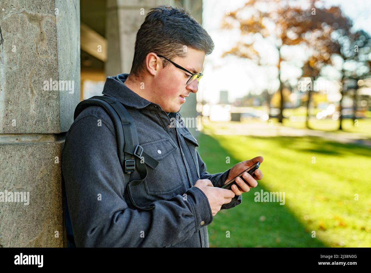 Nice Student with backpack outside university school Stock Photo - Alamy