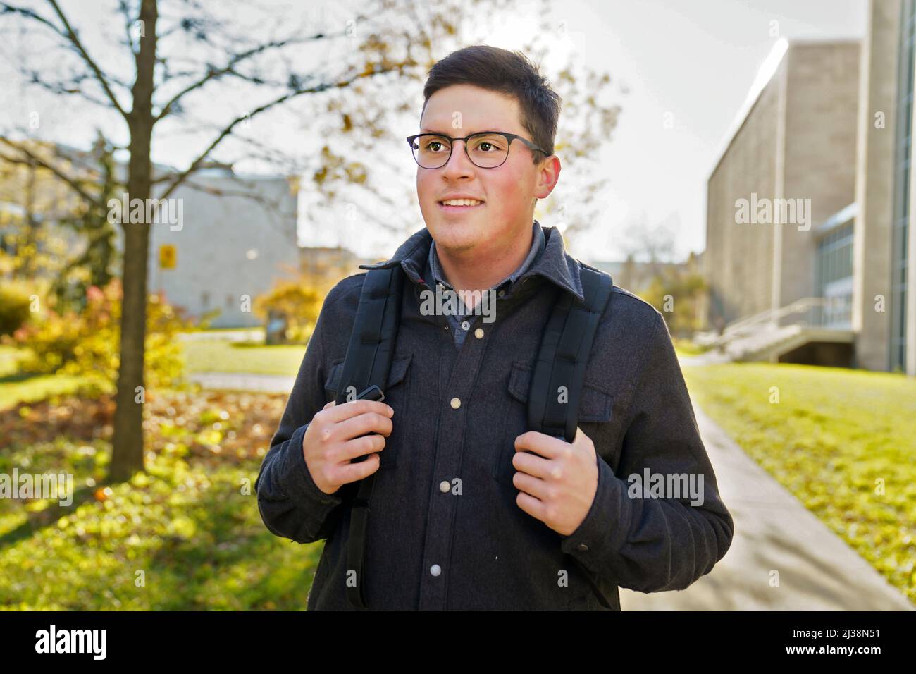 Nice Student with backpack outside university school Stock Photo - Alamy