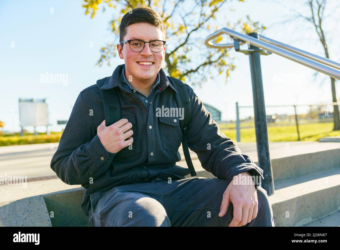 Nice Student with backpack outside university school Stock Photo - Alamy