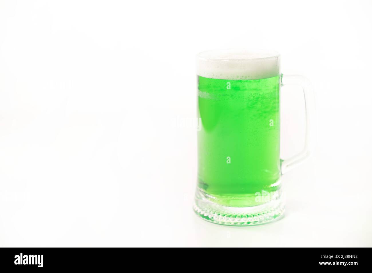 A pint of green beer for st patrick's day on a white background ...