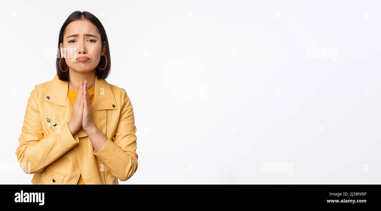 Image of hopeless asian woman begging, pleading, say sorry, looking ...