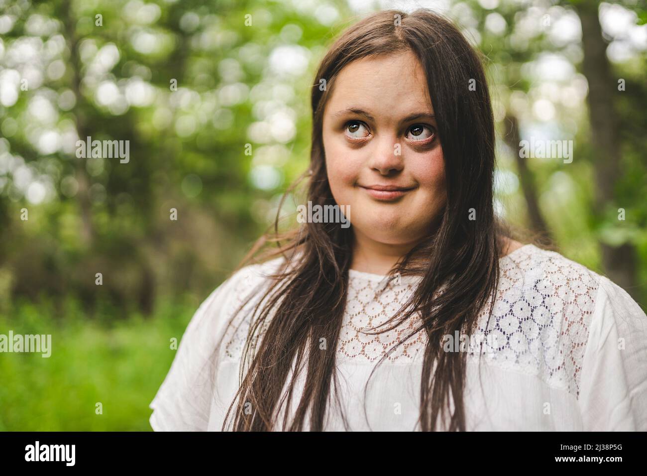 Portrait of trisomy adult outside having fun Stock Photo - Alamy
