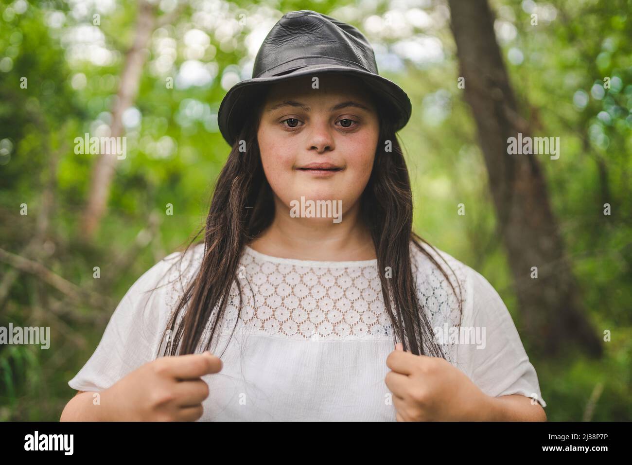 Portrait of trisomy adult outside having fun Stock Photo - Alamy