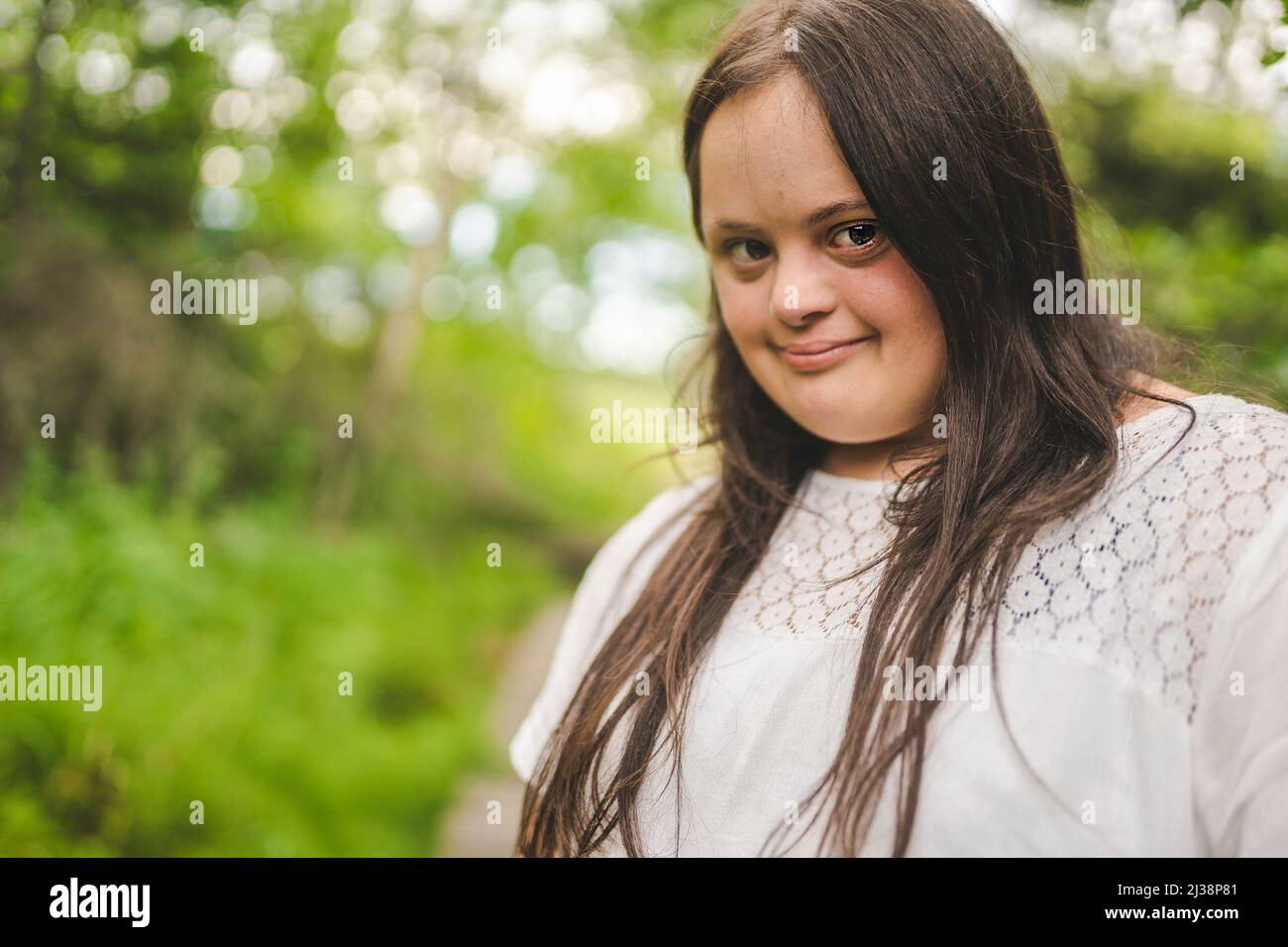 Portrait of trisomy adult outside having fun Stock Photo - Alamy