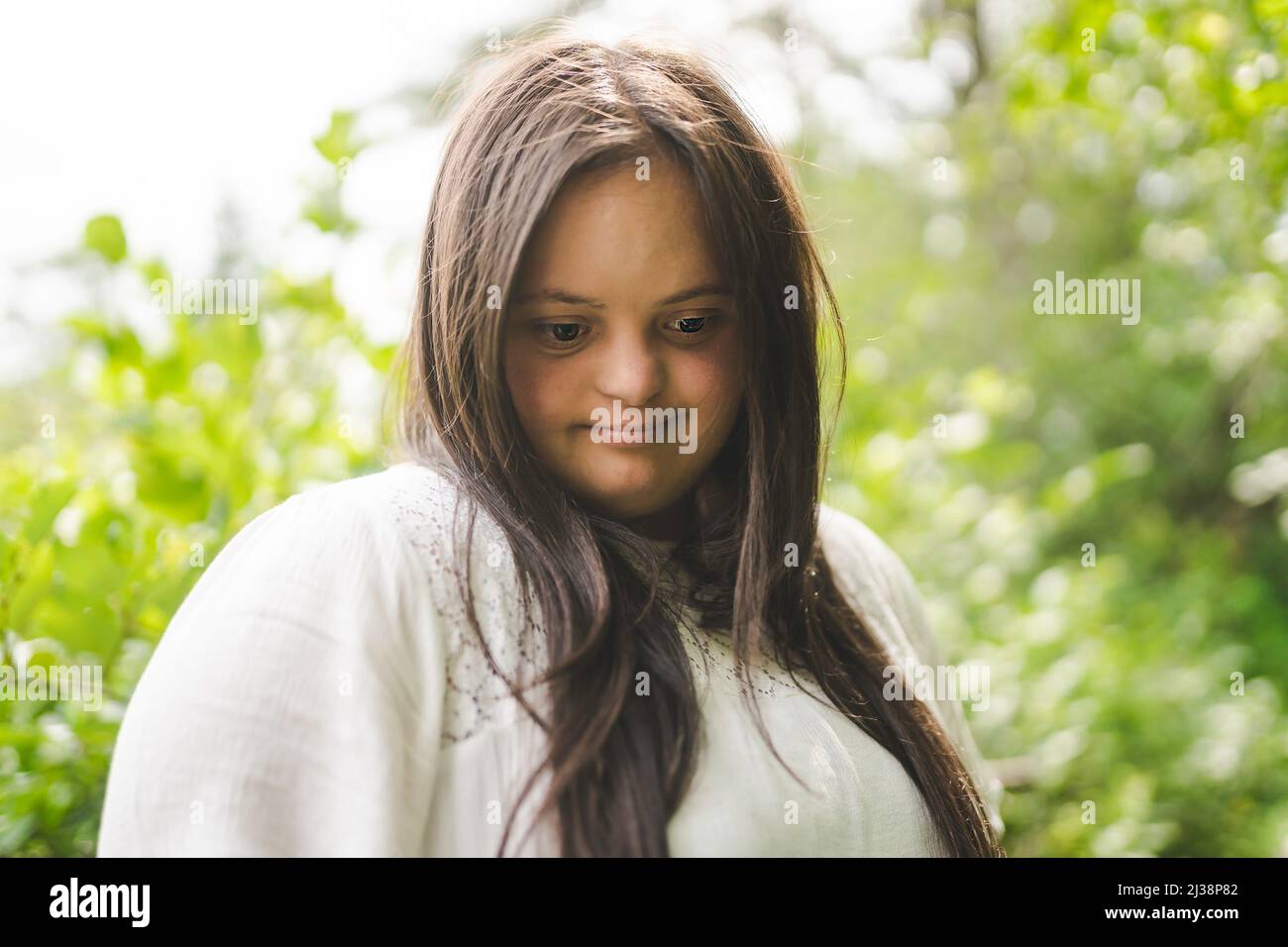 Portrait of trisomy adult outside having fun Stock Photo - Alamy