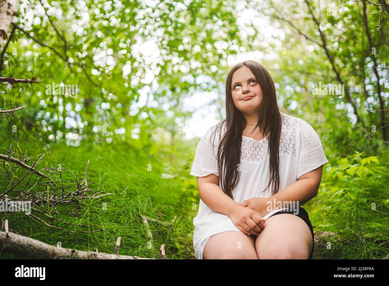 Portrait of trisomy adult outside having fun Stock Photo - Alamy