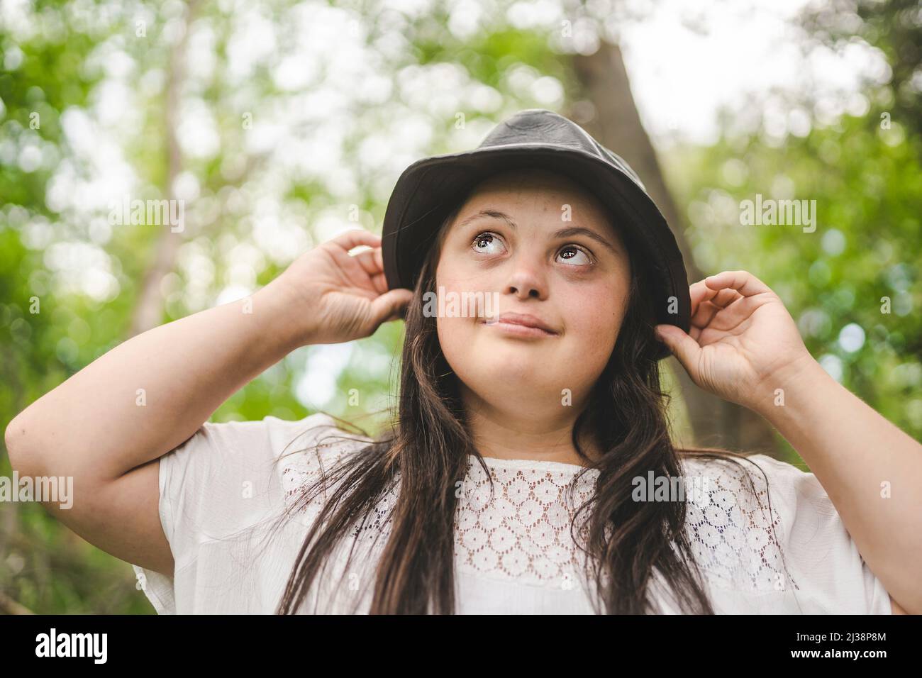 Portrait of trisomy adult outside having fun Stock Photo - Alamy